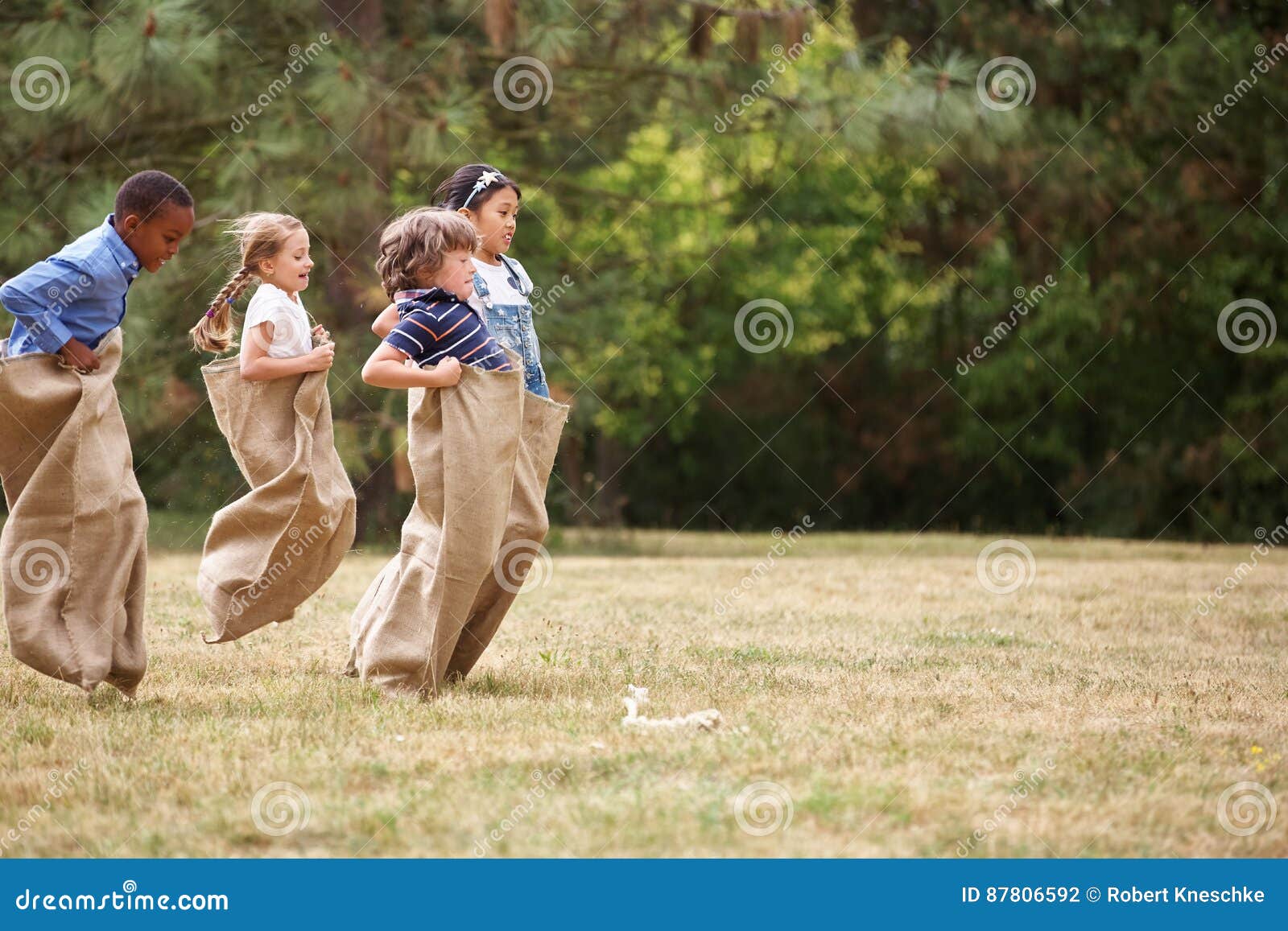 Kids at a sack race stock photo. Image of community, interracial - 87806592