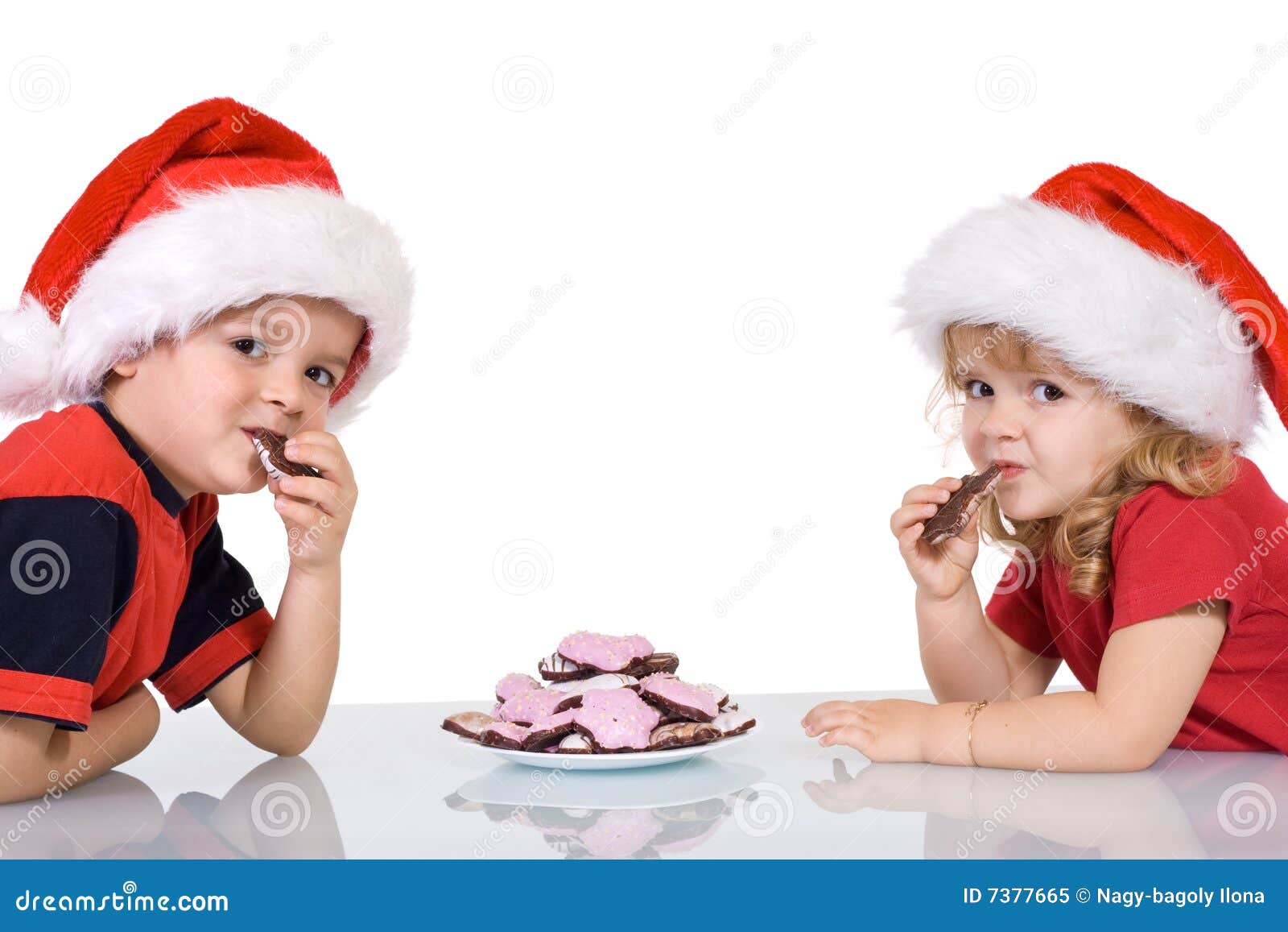 Kids with Santa Hats Eating Cookies Stock Image - Image of girl, food ...