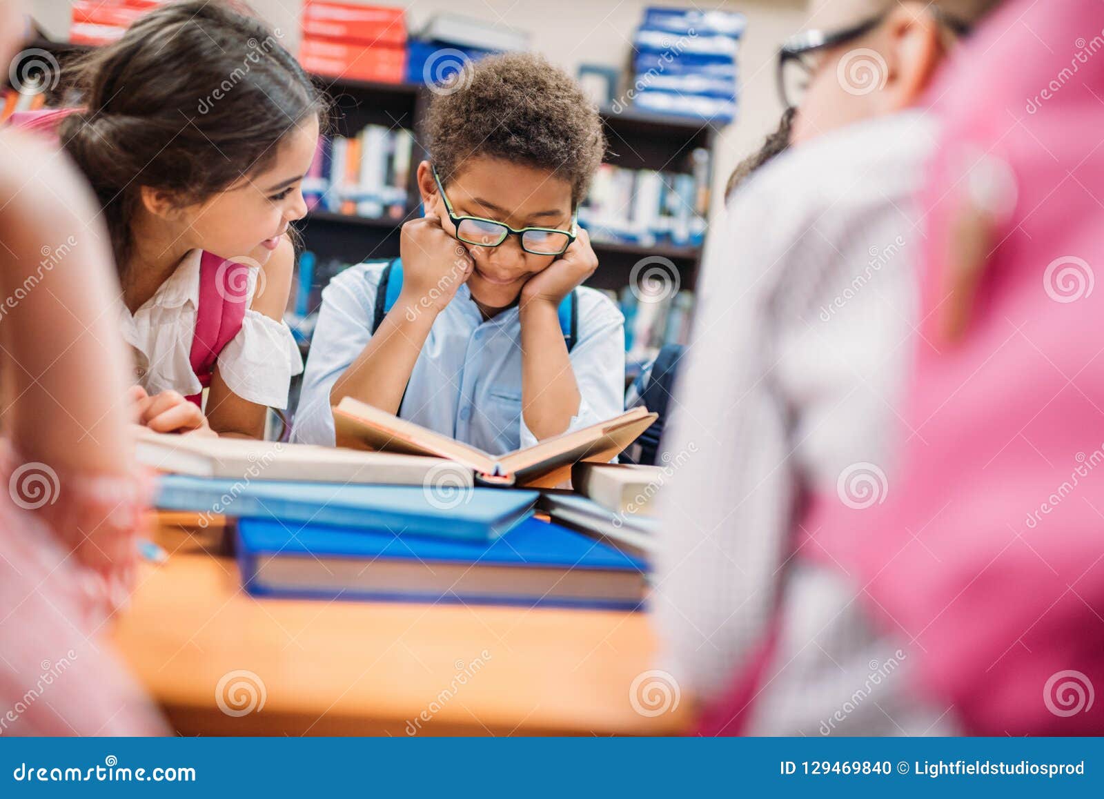 Kids in school library stock photo. Image of mutiethnic - 129469840
