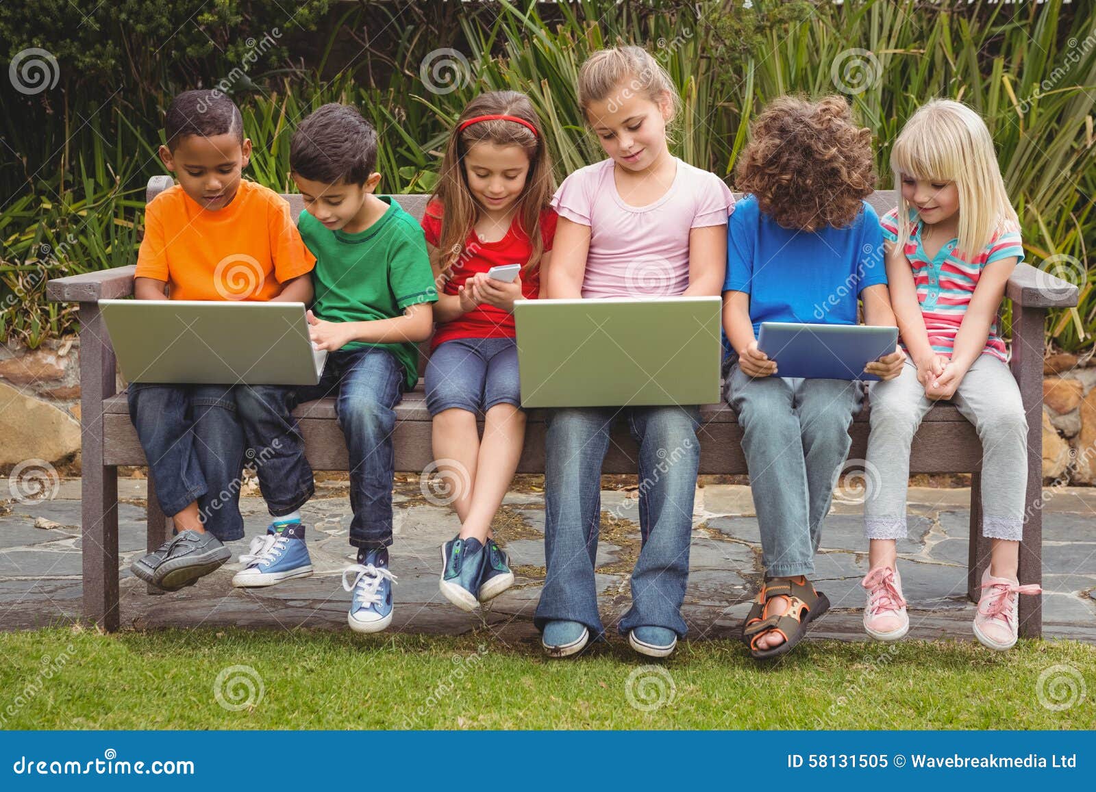 Kids Sitting on a Park Bench Stock Image - Image of group, female: 58131505