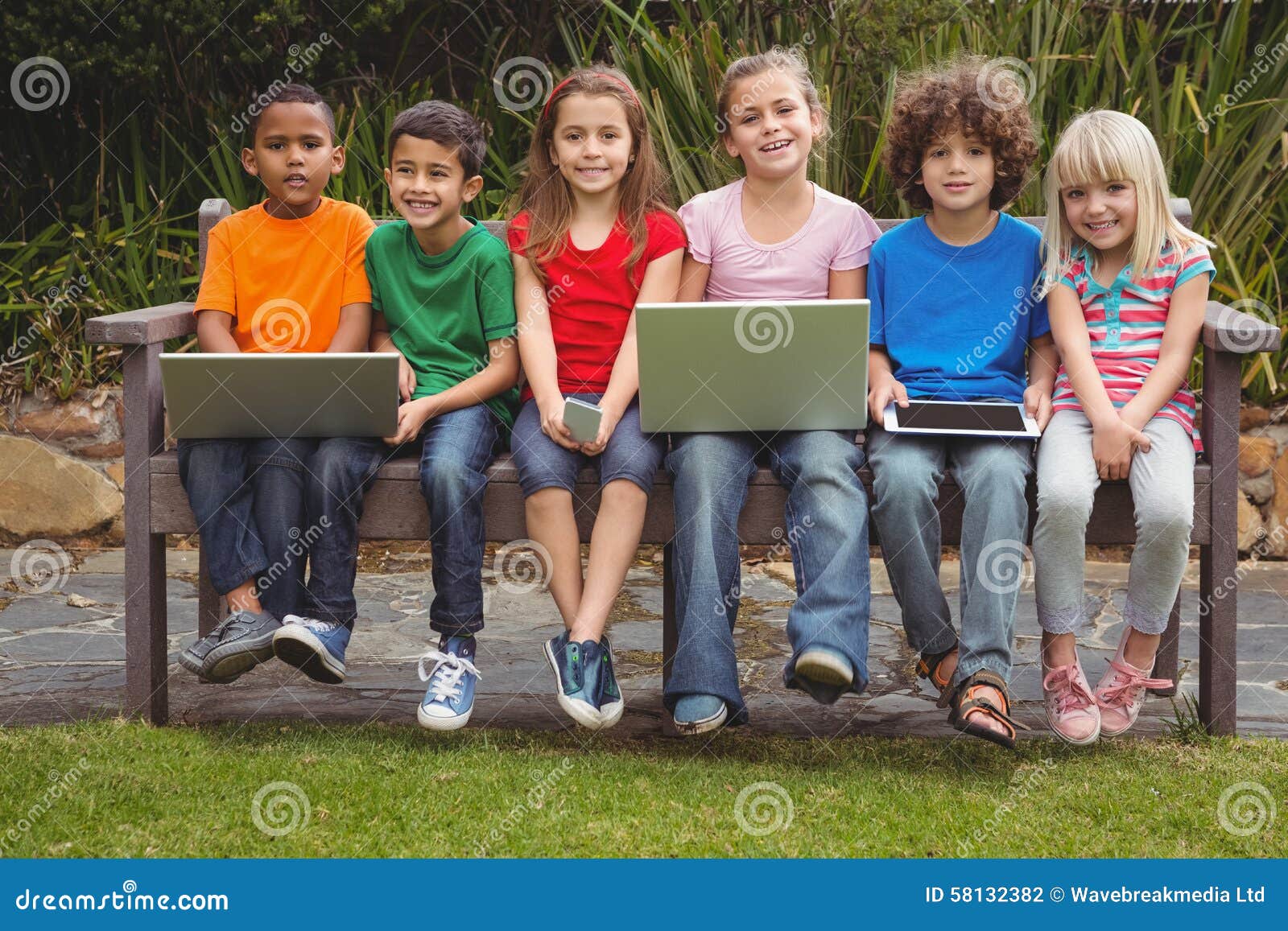 Kids Sitting on a Park Bench Stock Photo - Image of medium, green: 58132382