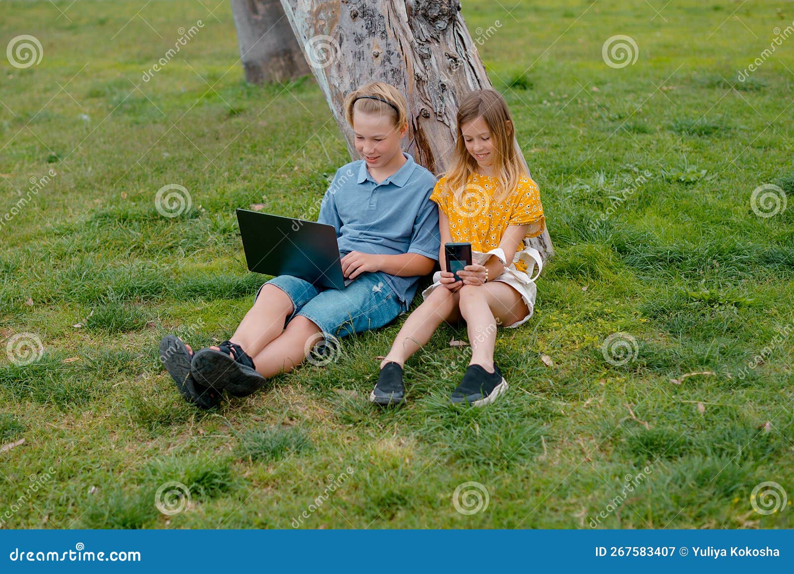Kids Sitting Under a Tree and Using Technology Stock Image - Image of ...