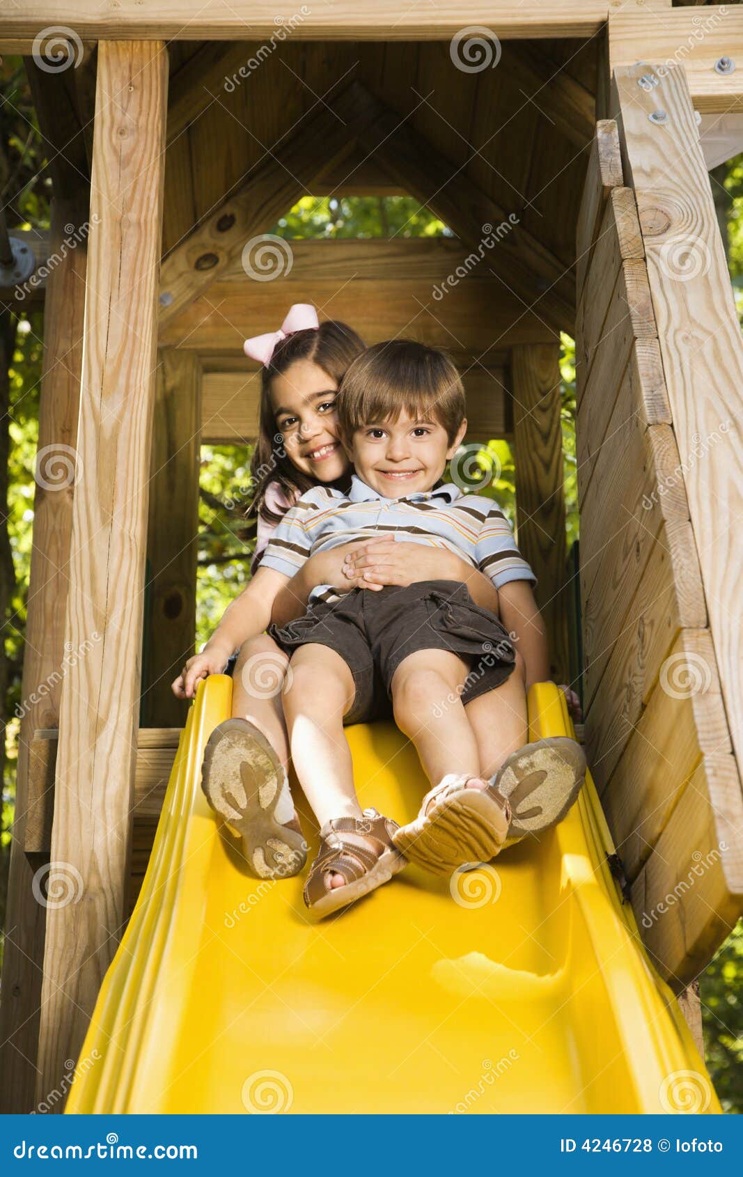 Kids on slide. stock photo. Image of looking, brunette - 4246728