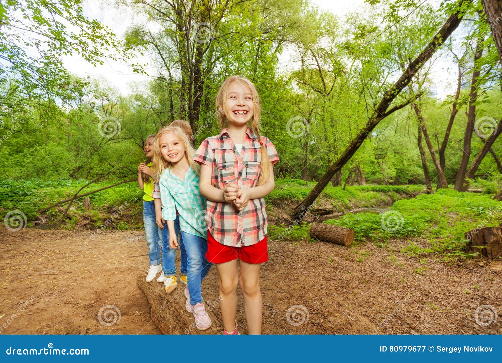 Kids Standing on a Log One after Another in Forest Stock Image - Image ...