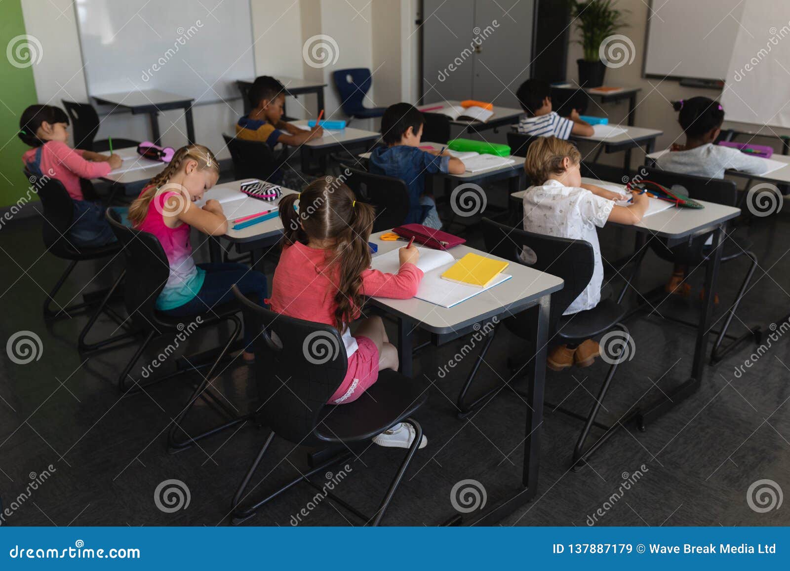Kids studying in classroom stock image. Image of drawing - 137887179