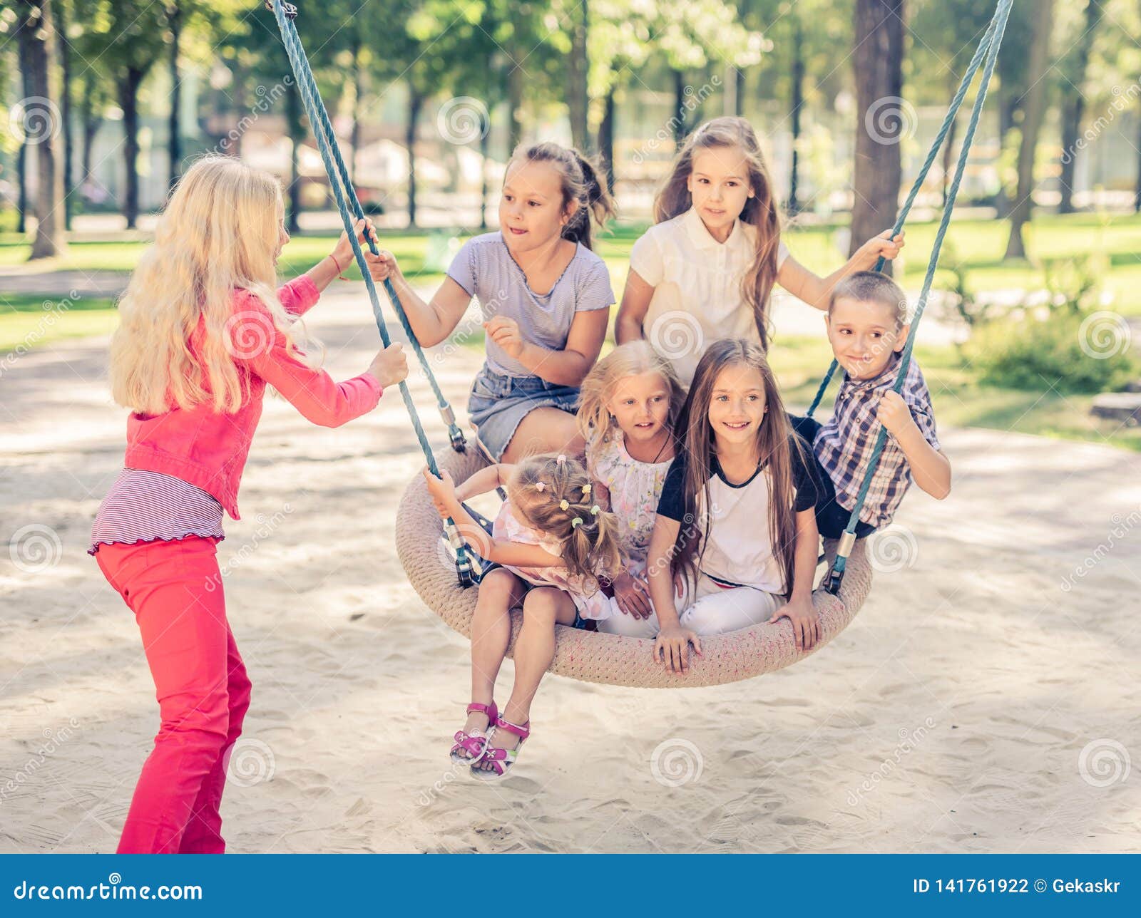 Kids on the Swing stock photo. Image of friends, park - 141761922