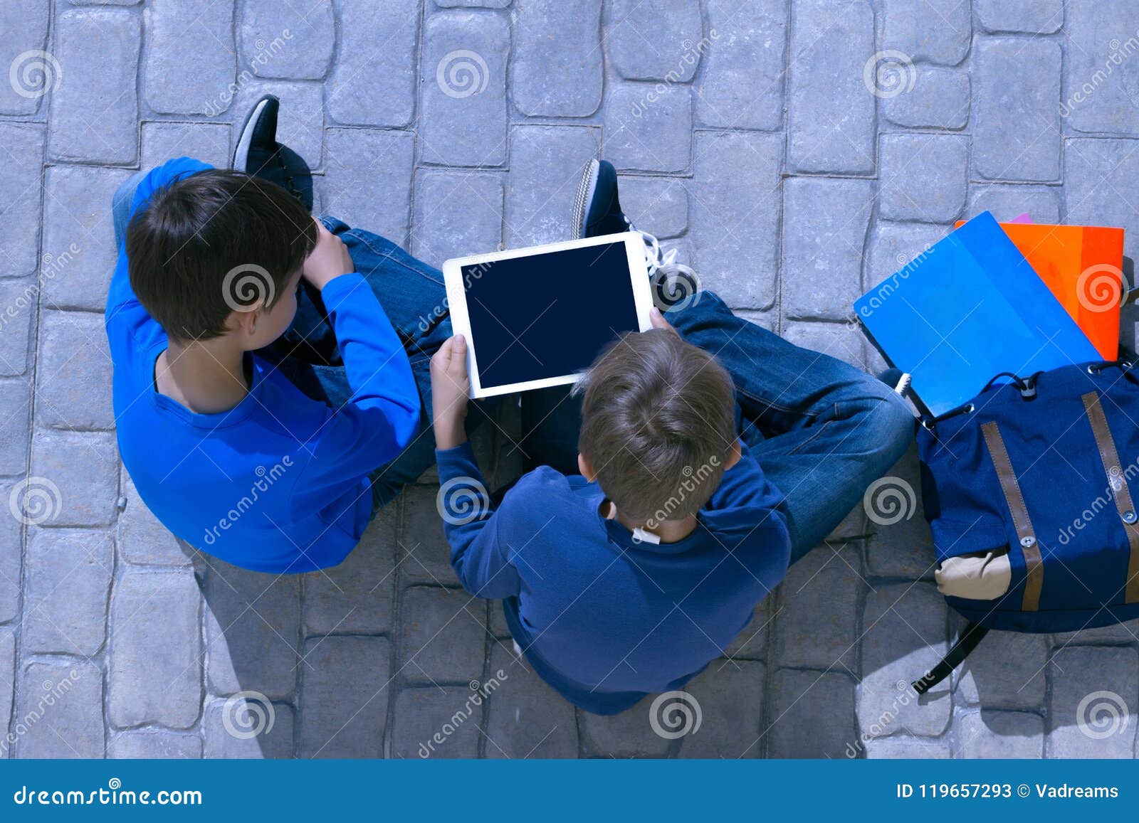Kids with Tablet Computer and Backpack Sitting Outdoors Stock Image ...