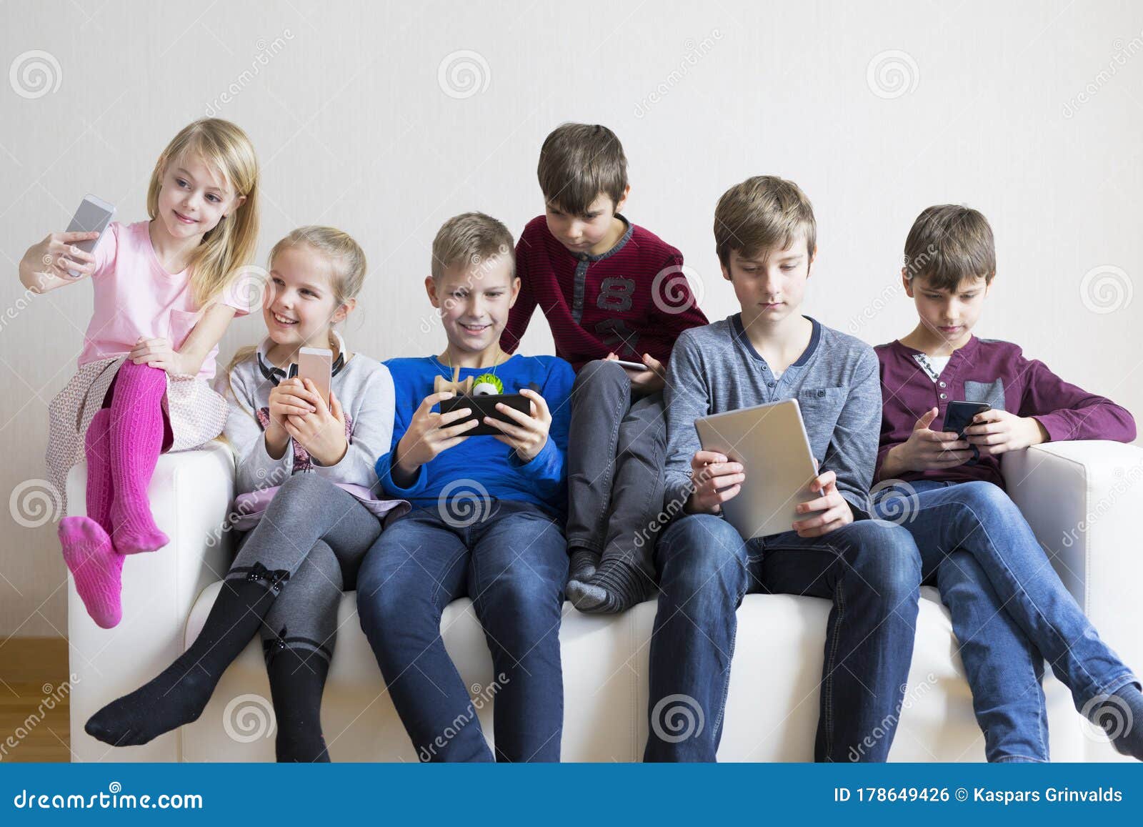 Kids using their gadgets stock photo. Image of children - 178649426