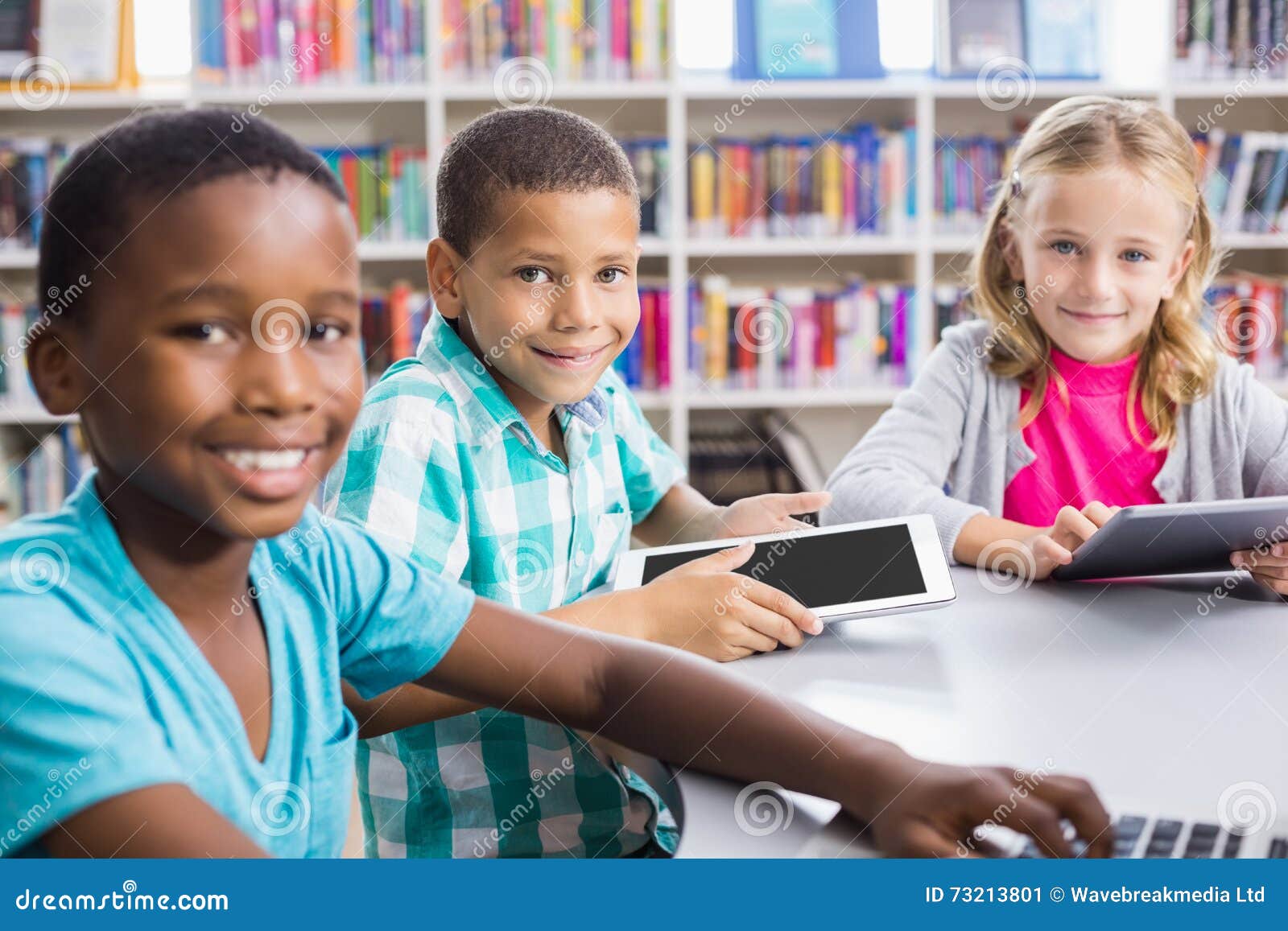Kids Using Laptop and Digital Tablet in Library Stock Image - Image of ...