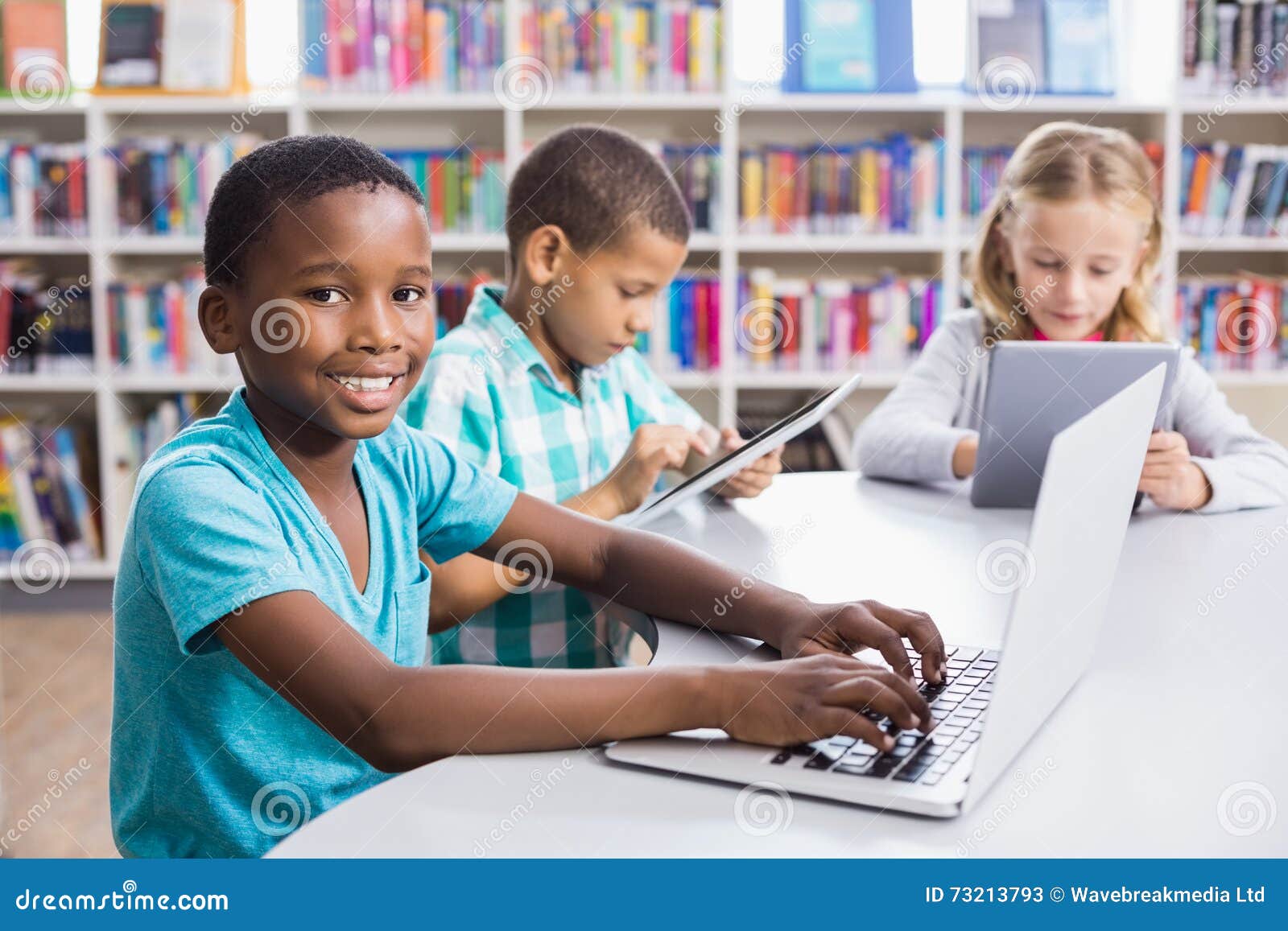 Kids Using Laptop and Digital Tablet in Library Stock Image - Image of ...