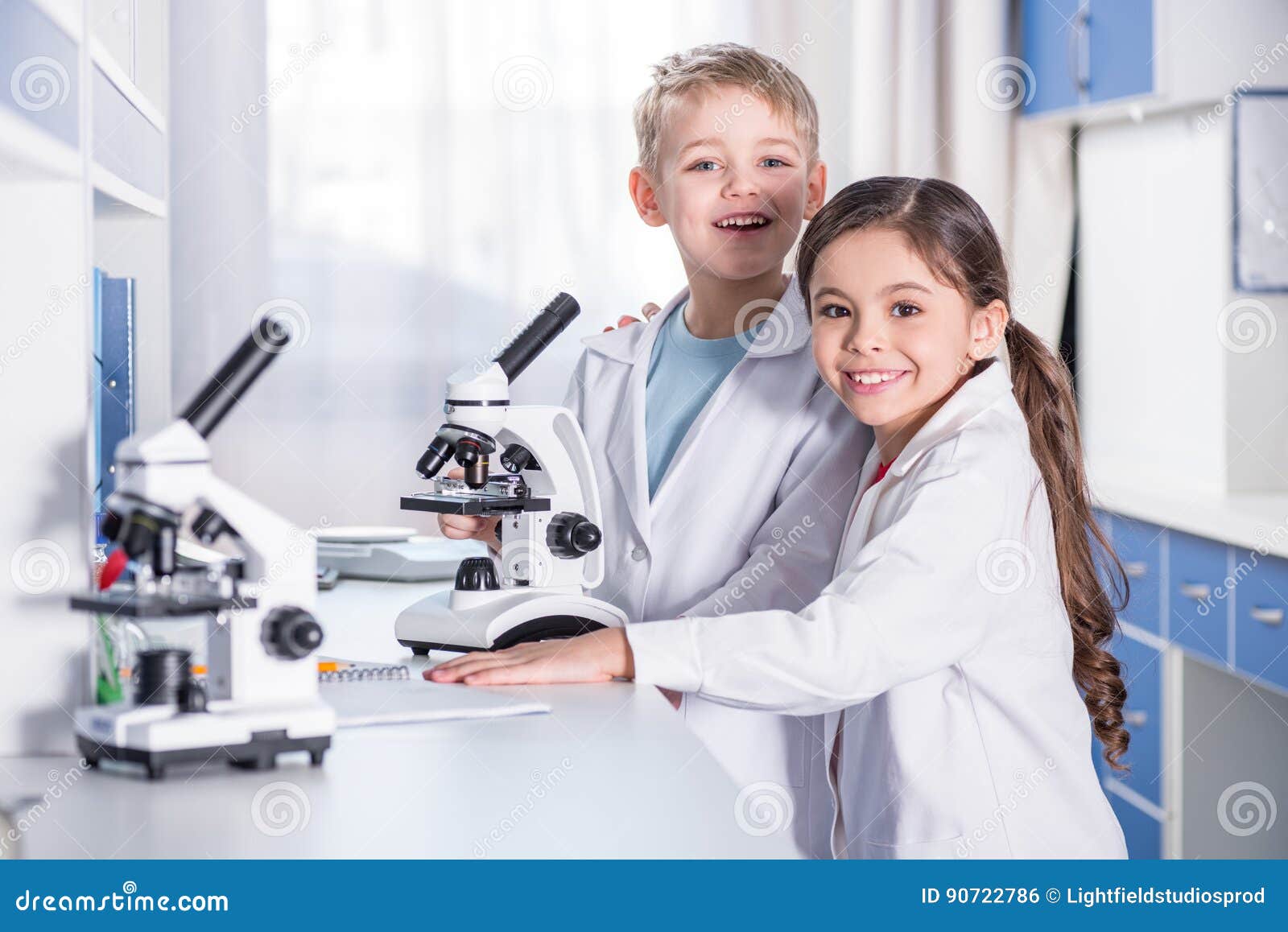 Kids using microscope stock photo. Image of experiment - 90722786