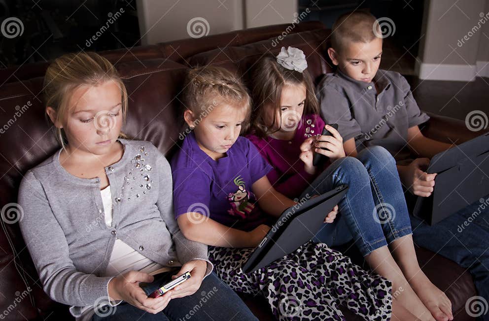 Kids using Mobile Devices stock image. Image of game - 23053625