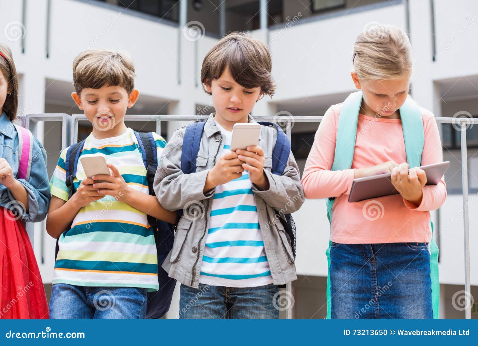Kids Using Mobile Phone and Digital Tablet on School Terrace Stock ...