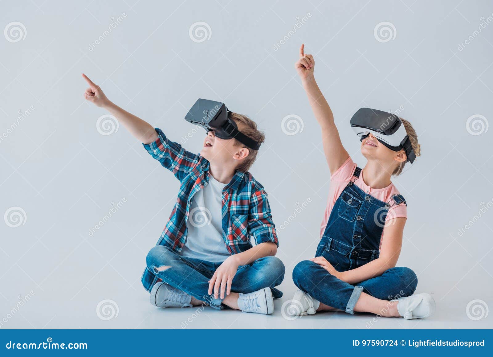 Kids Using Virtual Reality Headsets and Pointing Up with Finger while ...