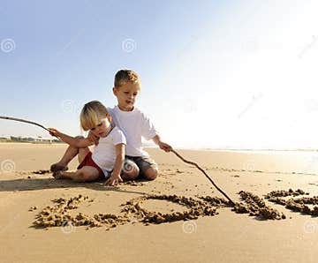 Kids writing in sand stock image. Image of coast, sister - 15822929