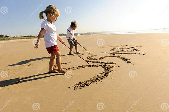 Kids writing in sand stock photo. Image of brother, happiness - 15822952