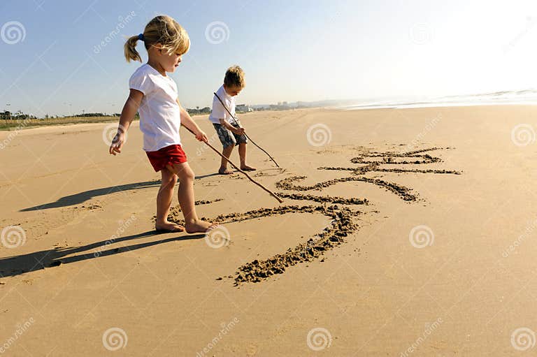 Kids writing in sand stock photo. Image of brother, happiness - 15822952