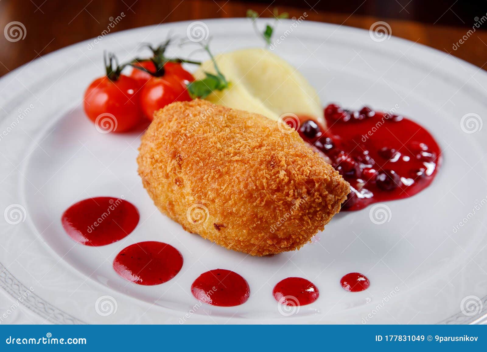 Kiev Chicken Cutlet with Mashed Potatoes and Berry Sauce on a White ... Kiev Chicken Cutlet with Mashed Potatoes and Berry Sauce on a White ...