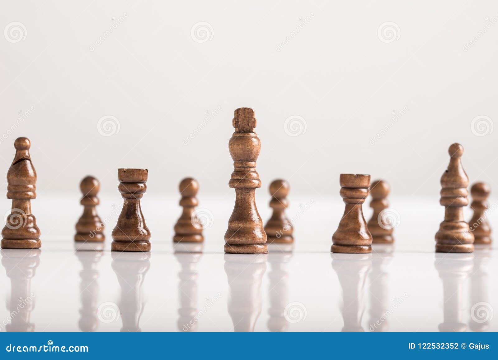 King Chess Piece with Chess Figures Standing on White Table Stock Photo ...