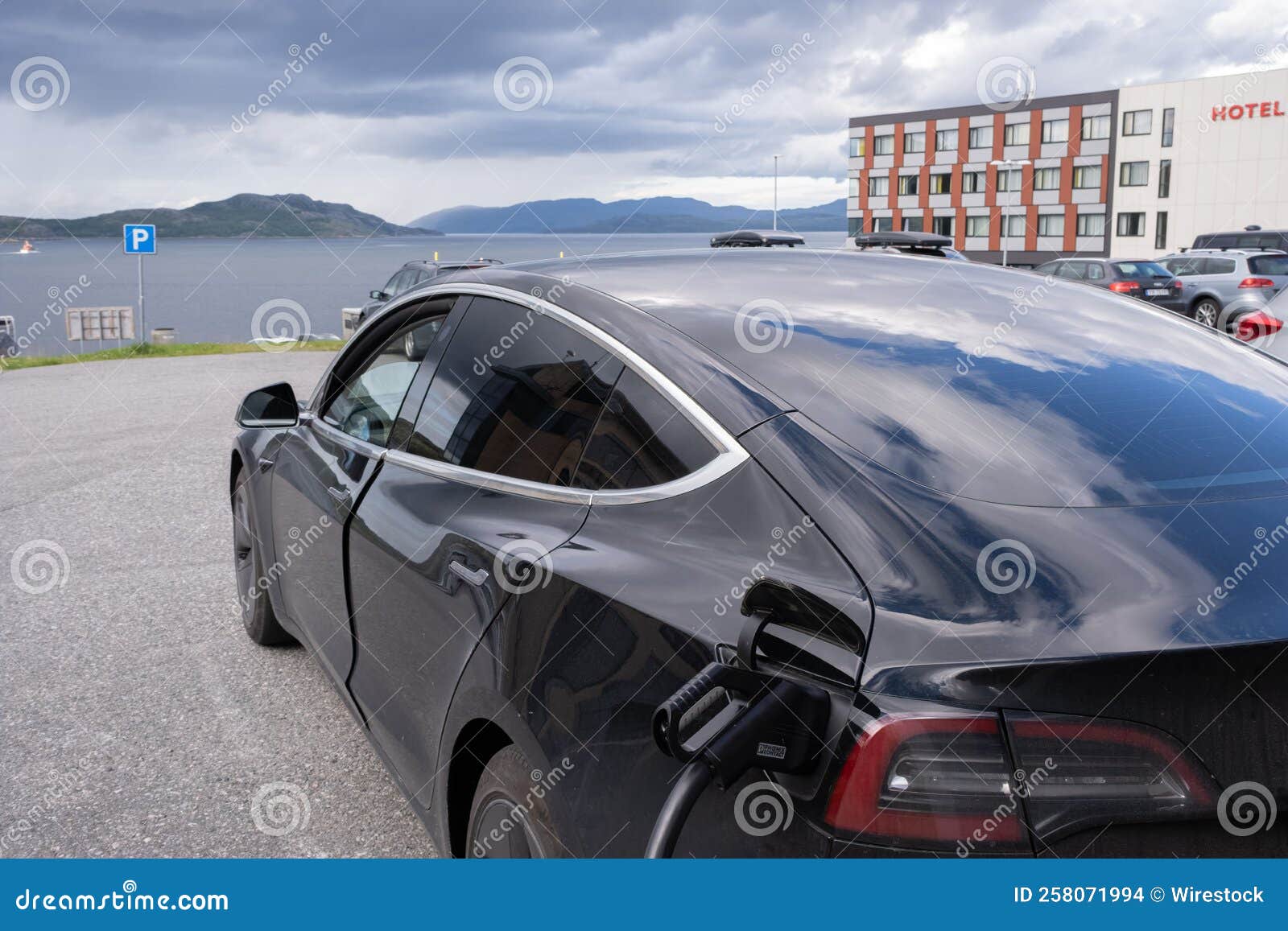 A Static Shot of a Solid Black Tesla Model 3 Dual Motor Charging at the ...