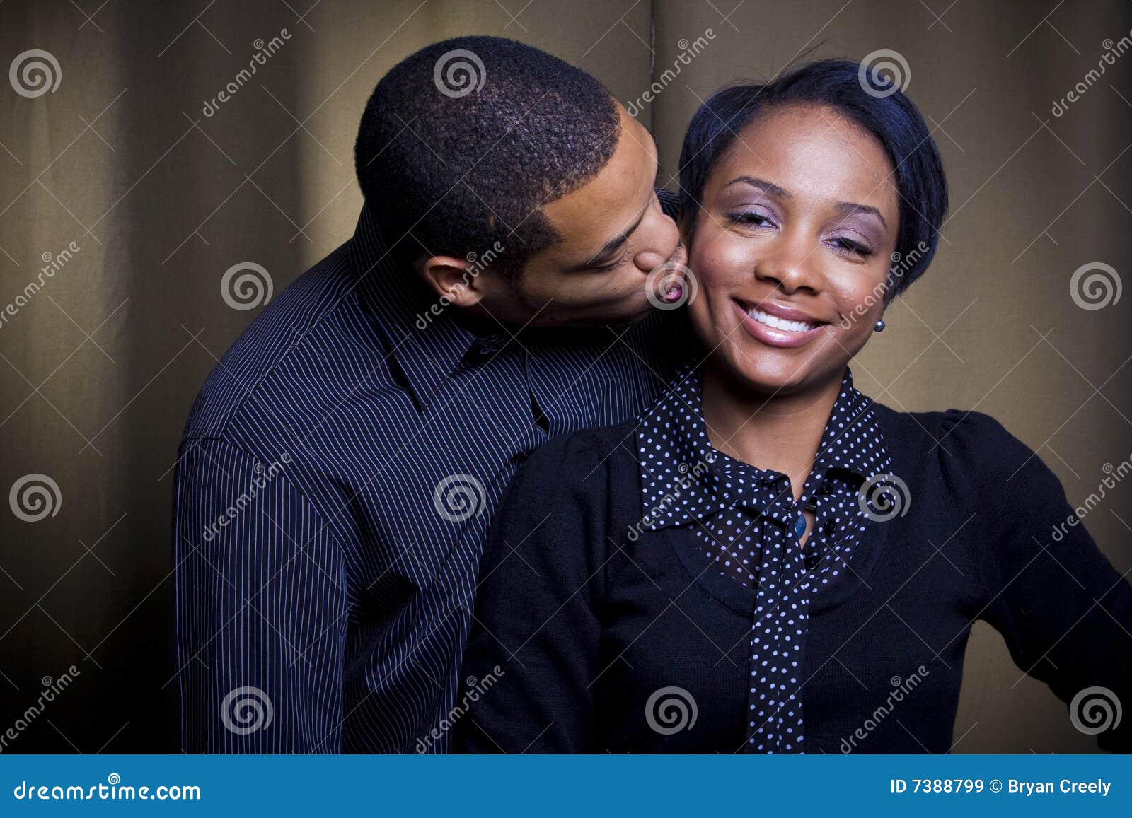 A kiss on the cheek stock image. Image of diversity, couple - 7388799