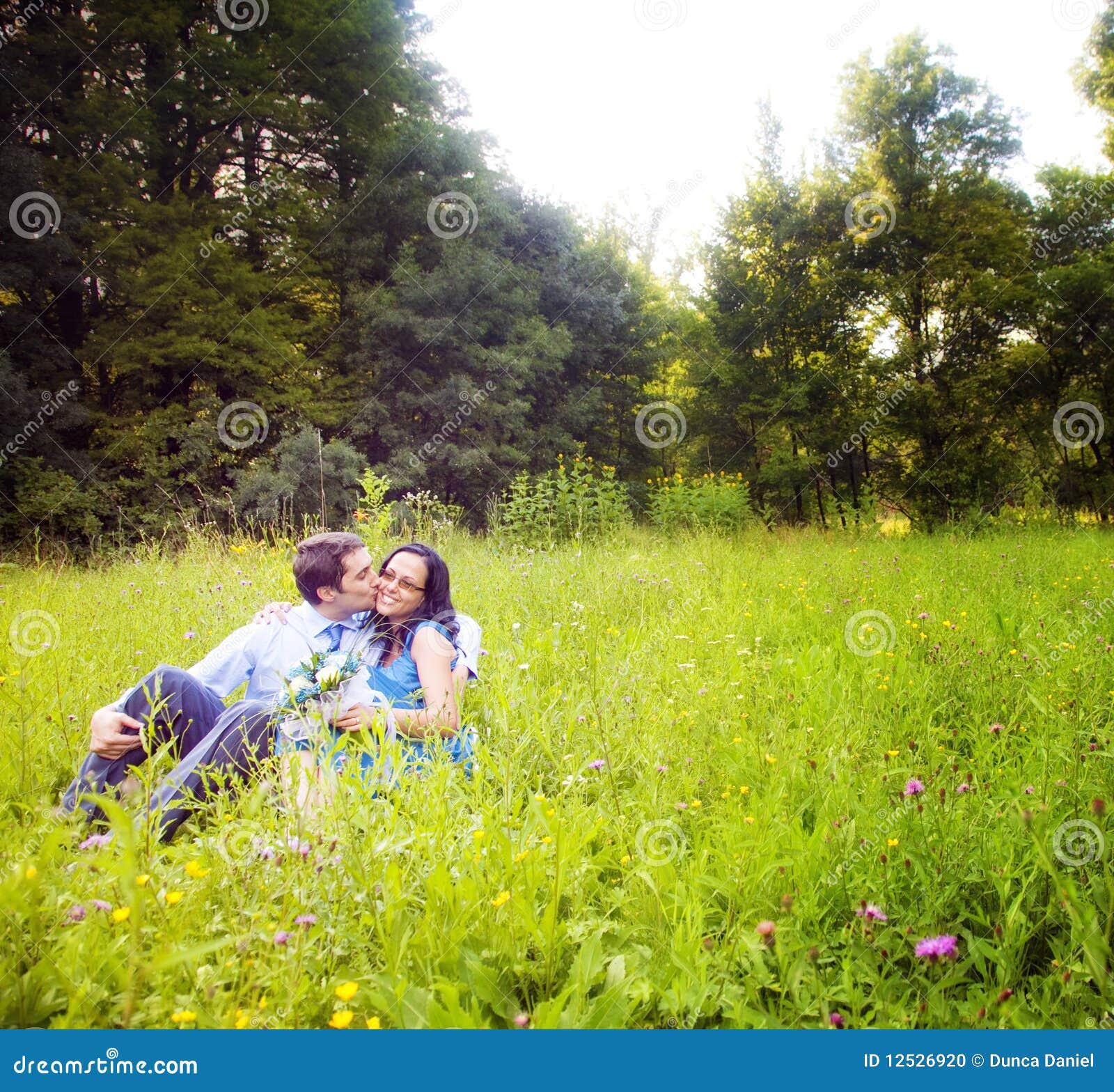 Kiss of Romantic Lovers in the Green Grass Stock Photo - Image of ...