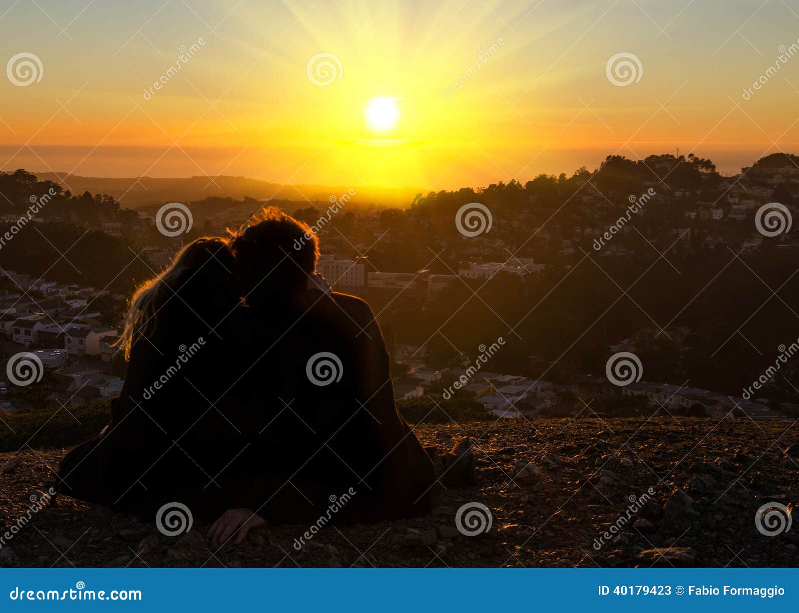 Kiss in the sun stock image. Image of hill, falling, romantic - 40179423