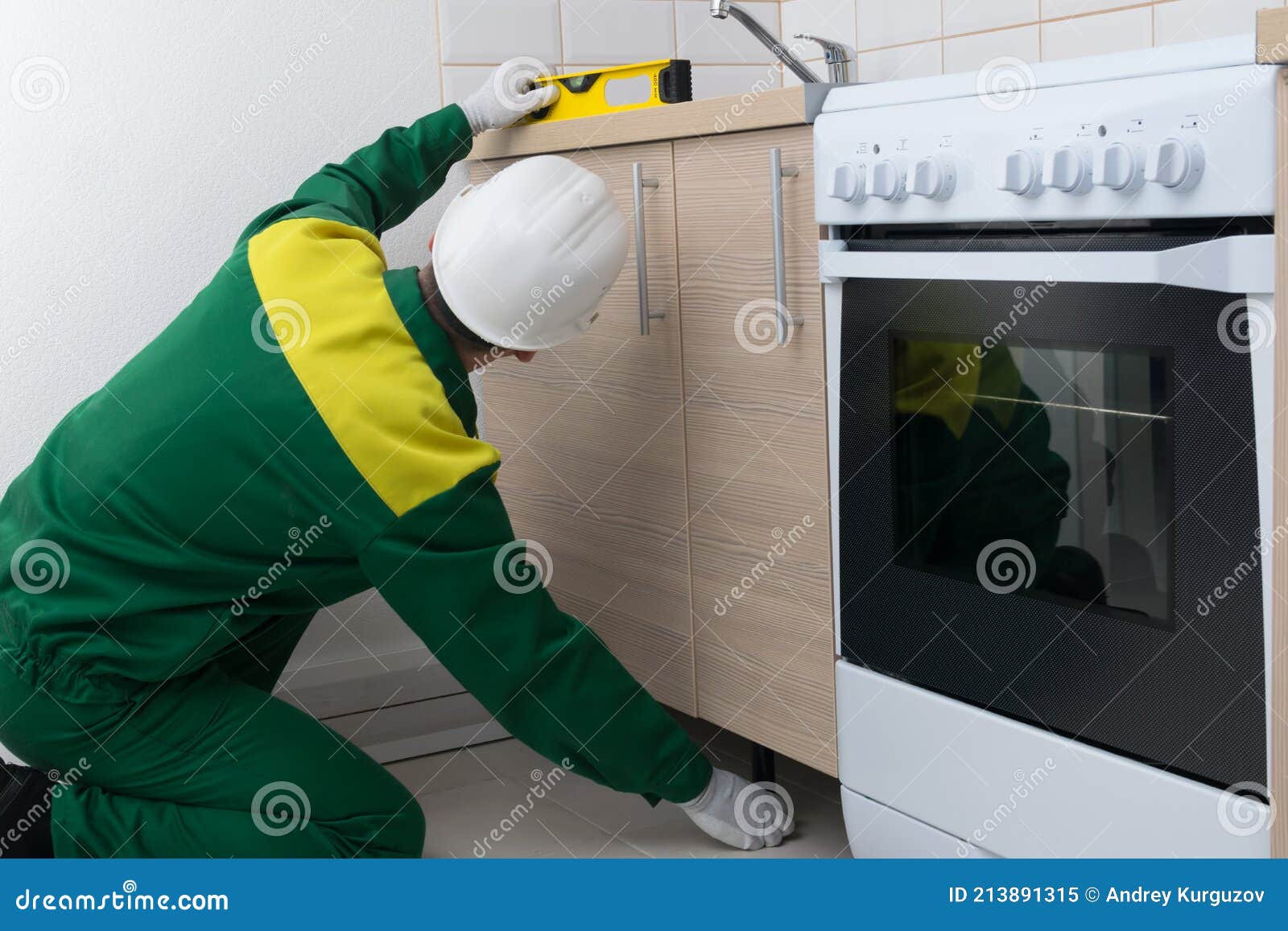 The Kitchen Assembly Master Adjusts the Level of the Top Surface of the ...