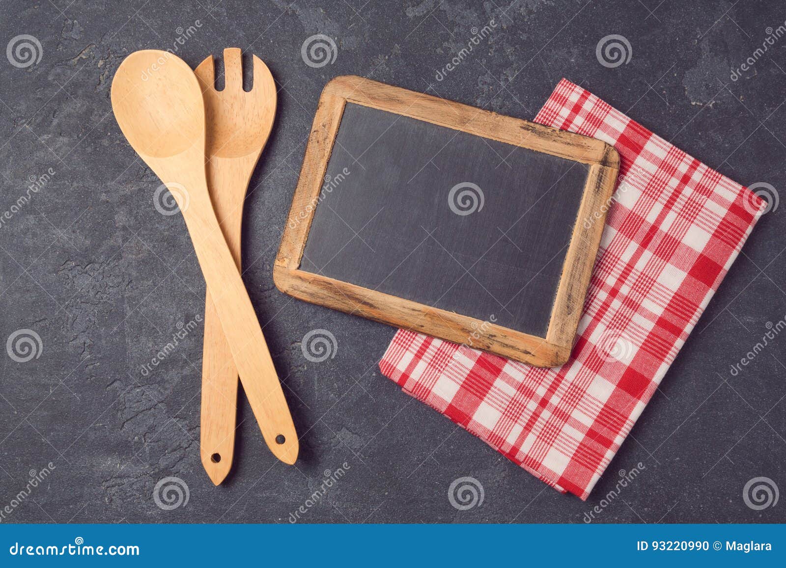 Kitchen Background with Chalkboard, Tablecloth and Utensils Over Dark ...