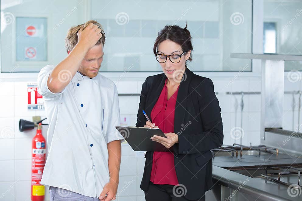 Kitchen Chef Being Supervised by Restaurant Manager Stock Image - Image ...