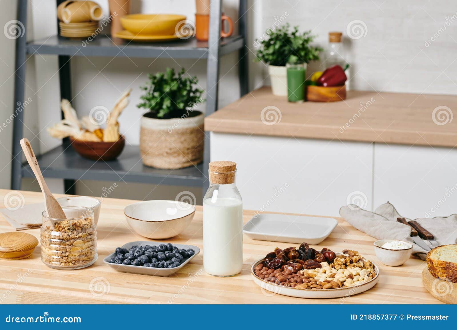 Kitchen Counter and Shelves with Bowls and Plates and Table with Food ...