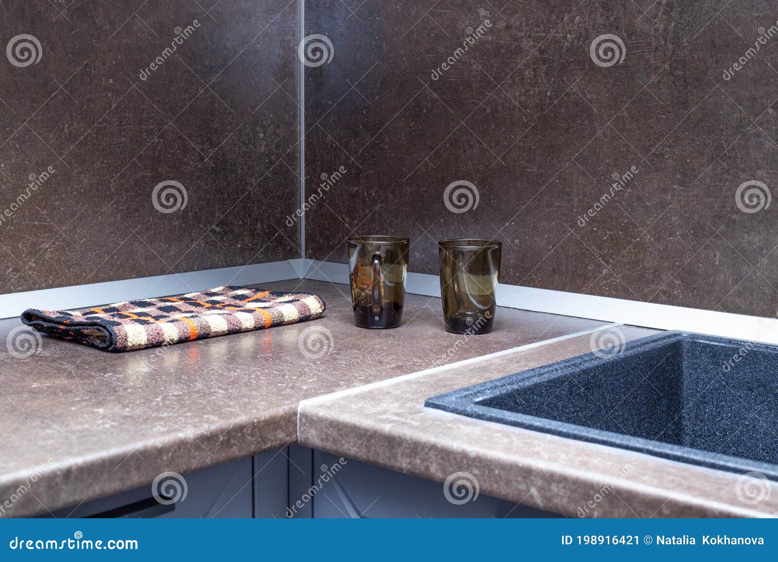 The Kitchen Countertop and Apron are Brown with a Black Stone Sink ...