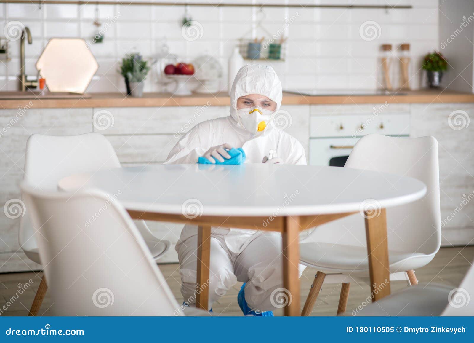 Woman in White Workwear and Protective Gloves Doing Disinfection in the ...