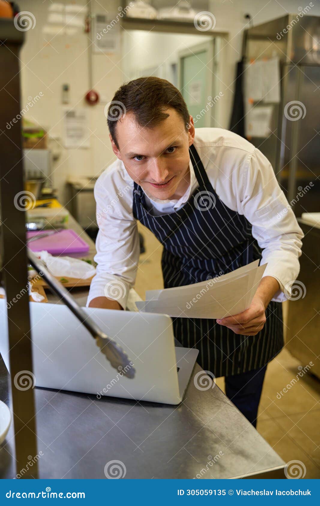 Kitchen Employee Works with Documents at the Kitchen Rack Stock Image ...