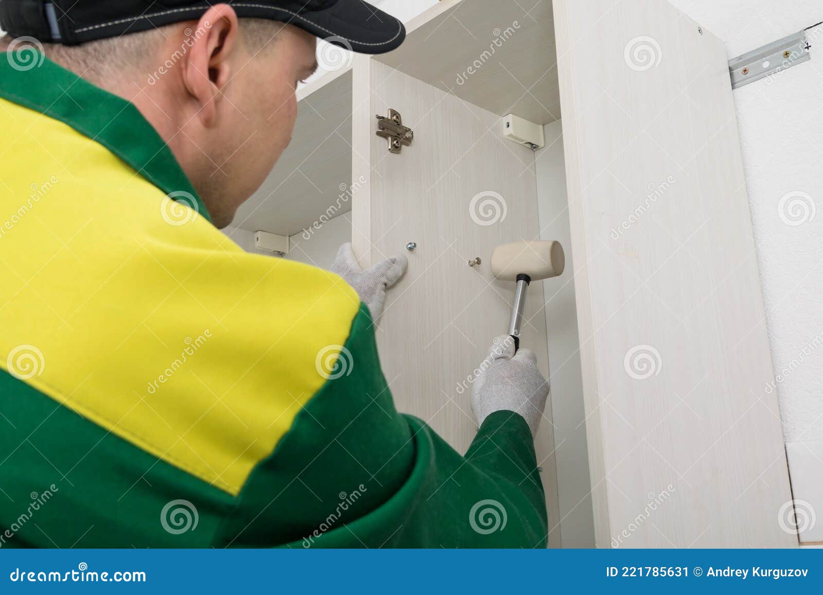 Kitchen Furniture Assembler Assembles the Top Cabinets with a Rubber ...