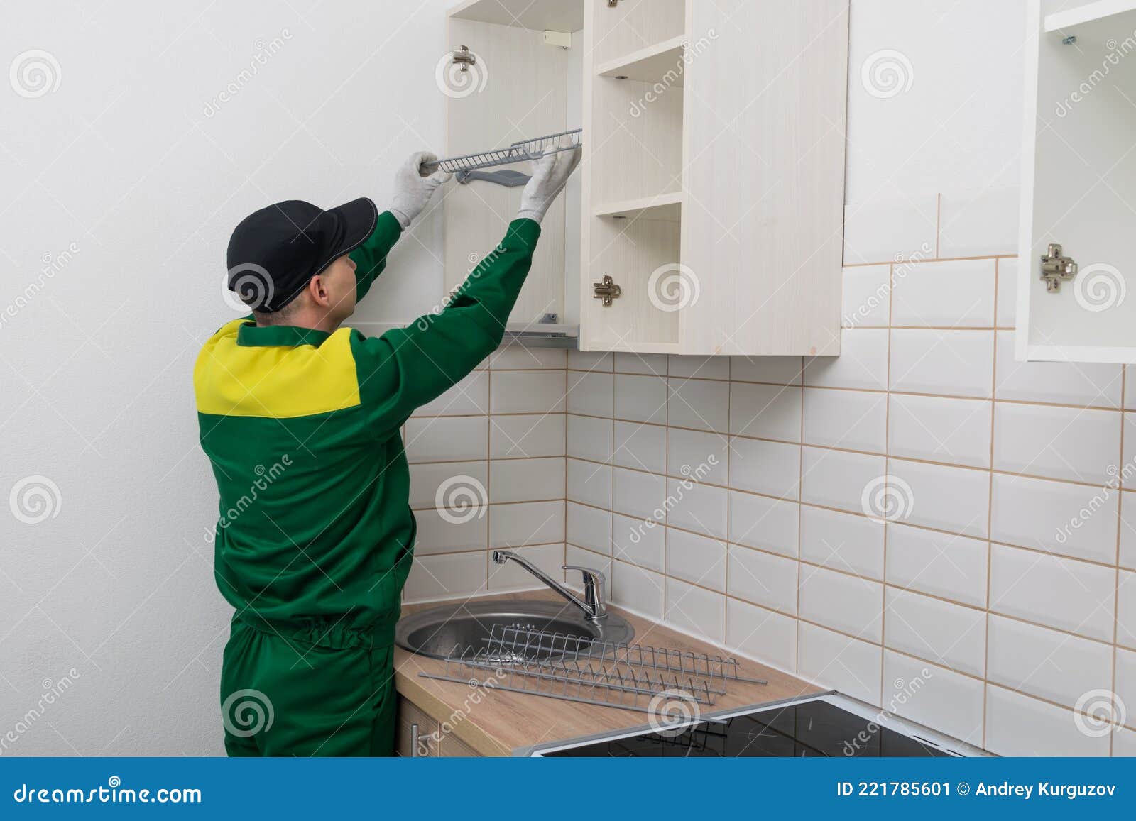 Kitchen Furniture Assembly and Fitter Assembles the Upper Cabinets ...