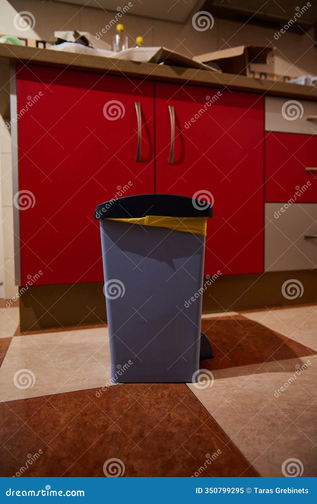 Kitchen Garbage Bin in a Clean Modern Kitchen with Red Cabinets Stock ...