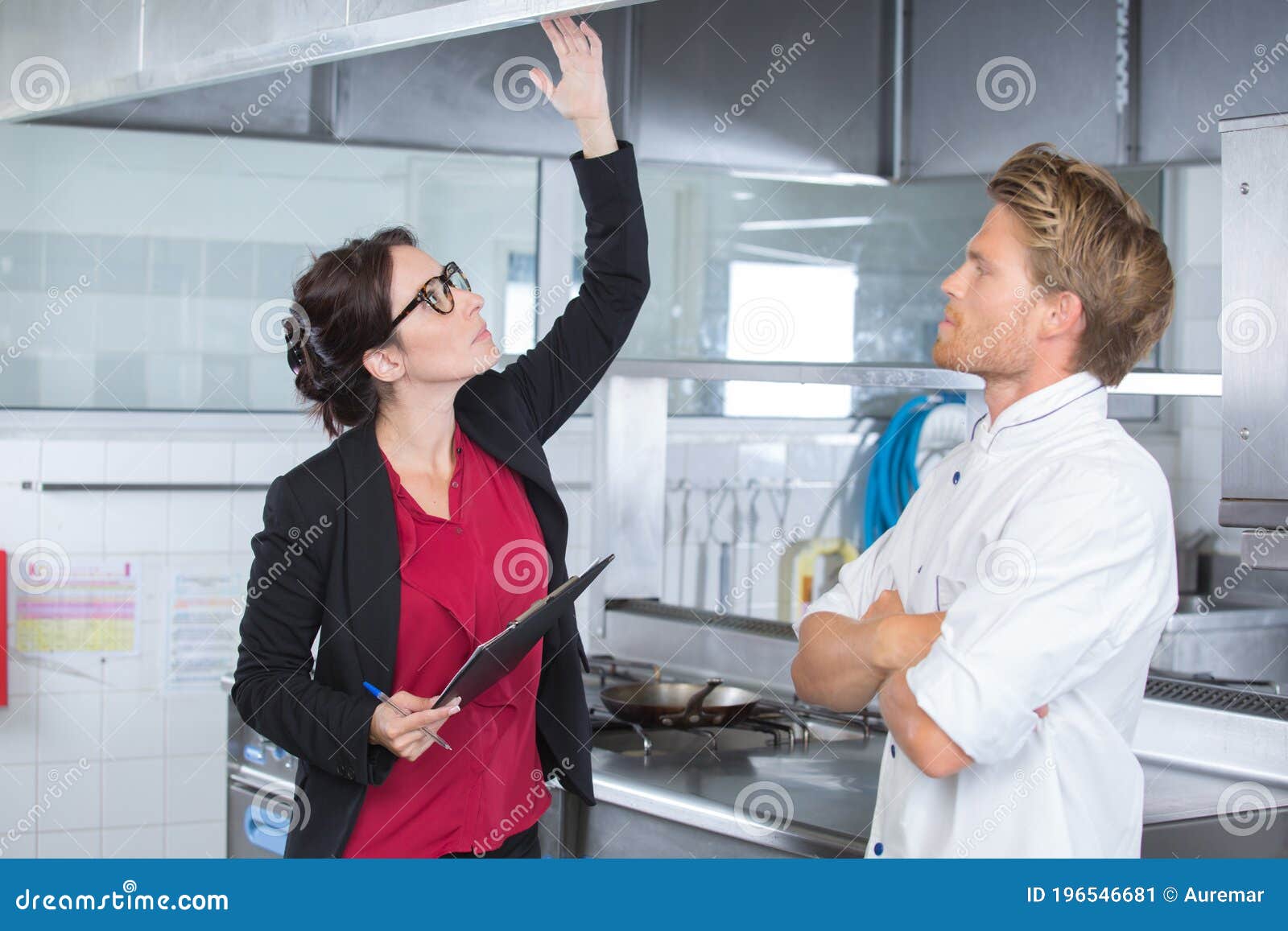 Kitchen Inspector Feeling Around Overhead Extractor Stock Image - Image ...