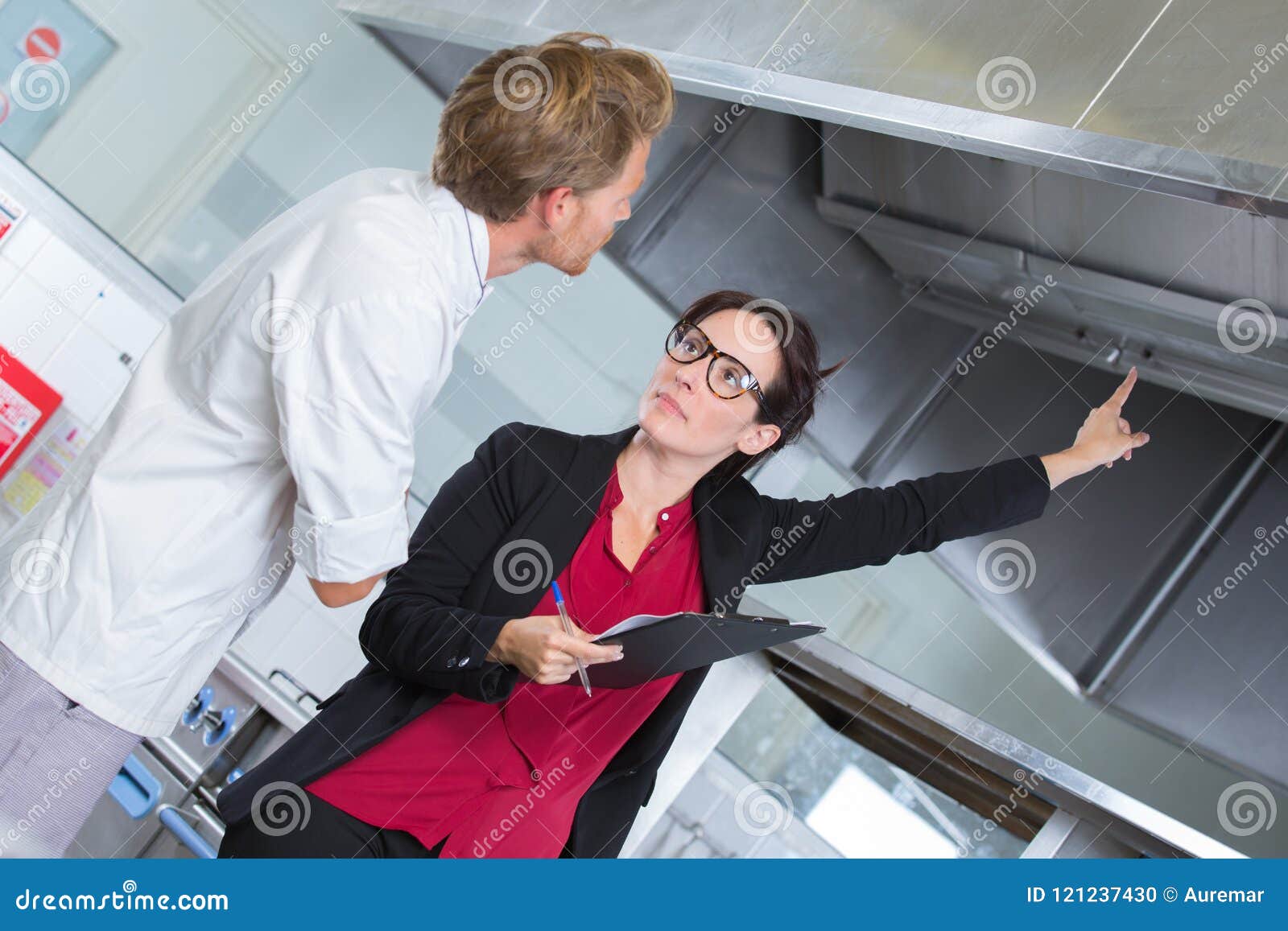 Kitchen Inspector Pointing To Extractors Stock Photo - Image of ...