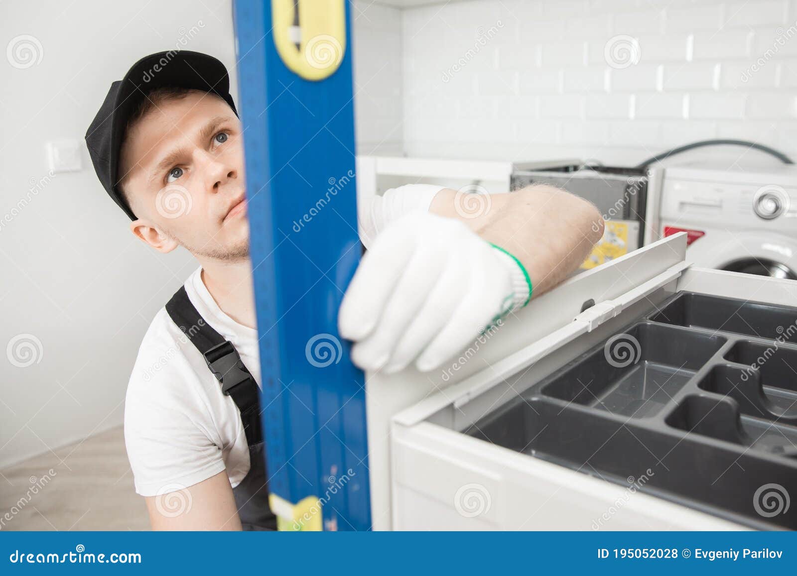 Kitchen Installation Man. Worker Assembling Furniture Sets Surface ...