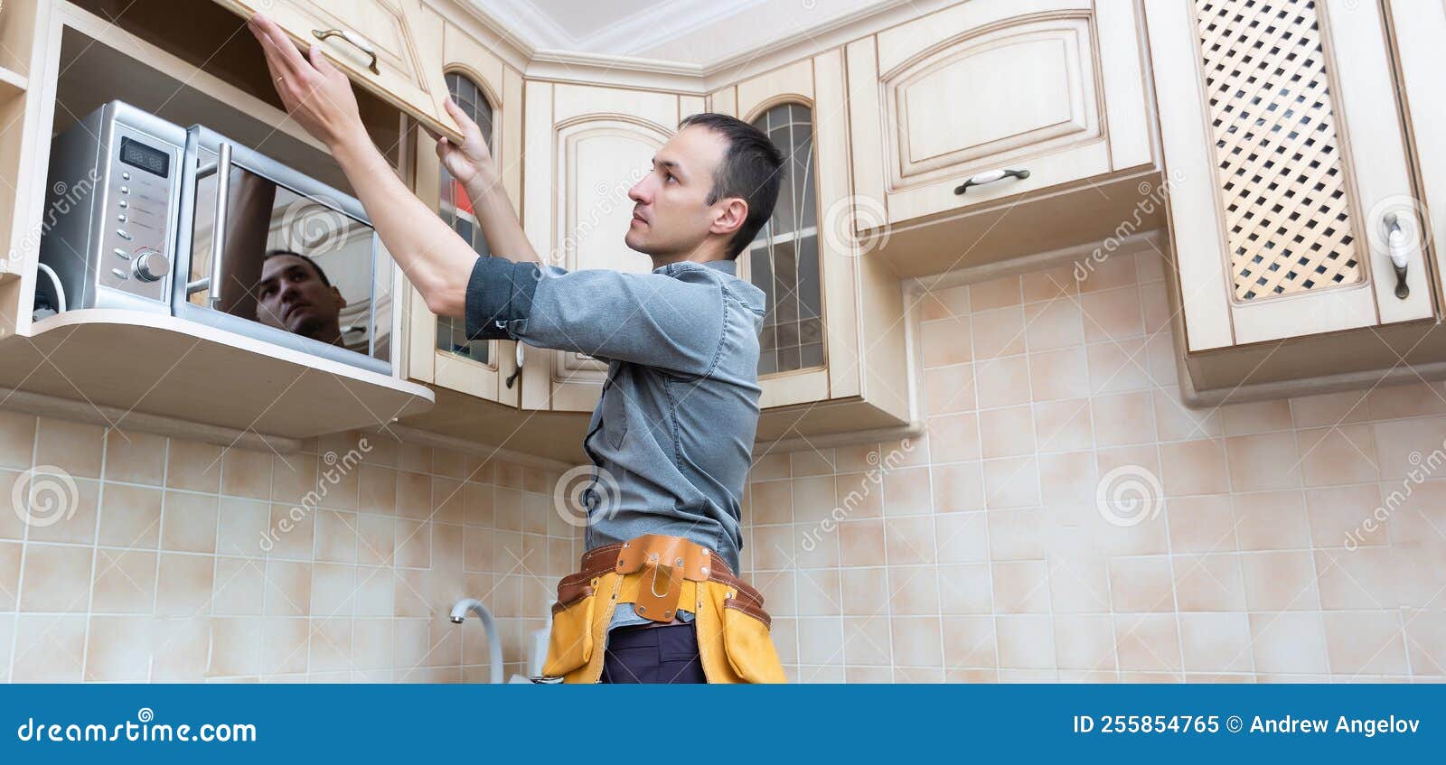 Kitchen Installation. Worker Assembling Furniture Stock Image - Image ...