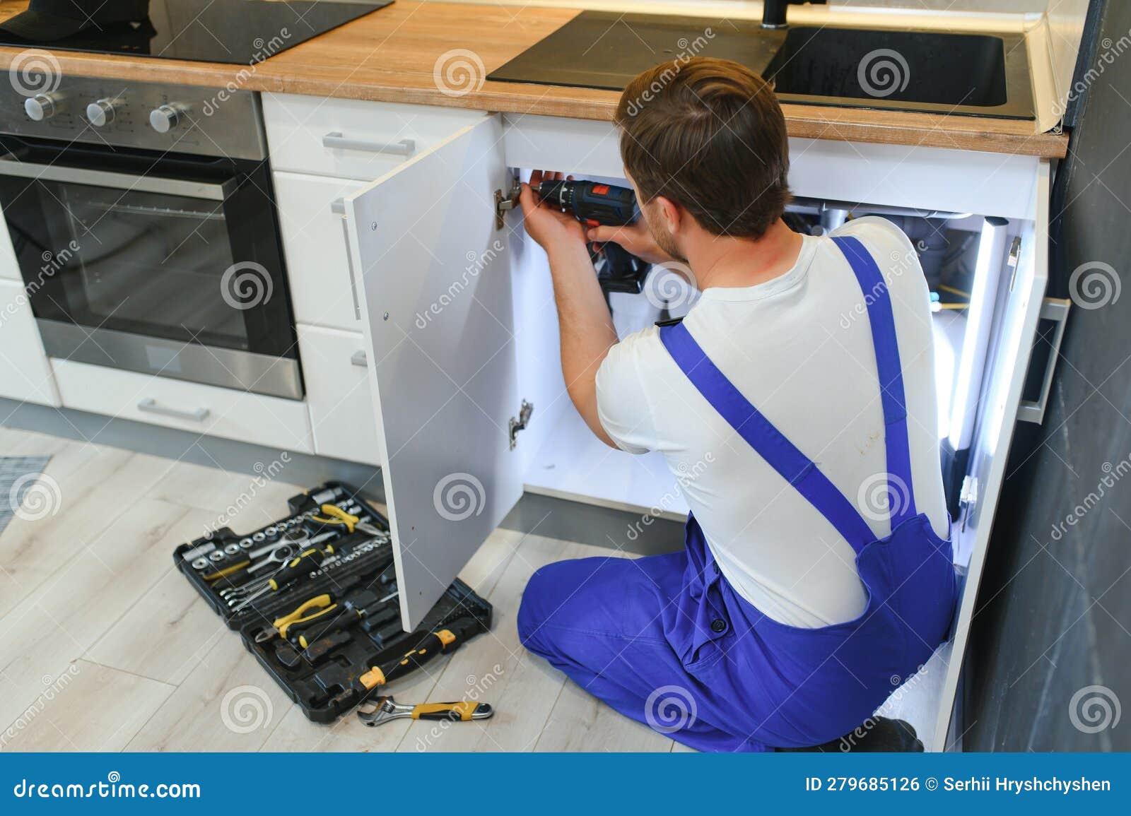 Kitchen Installation. Worker Assembling Furniture Stock Photo - Image ...
