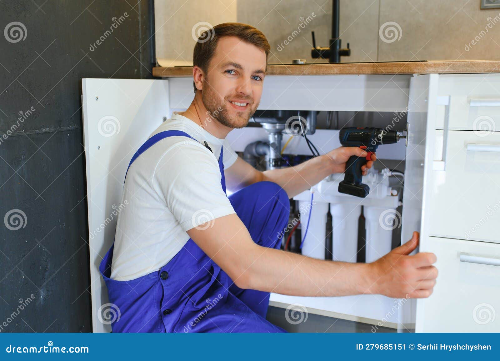 Kitchen Installation. Worker Assembling Furniture Stock Image - Image ...