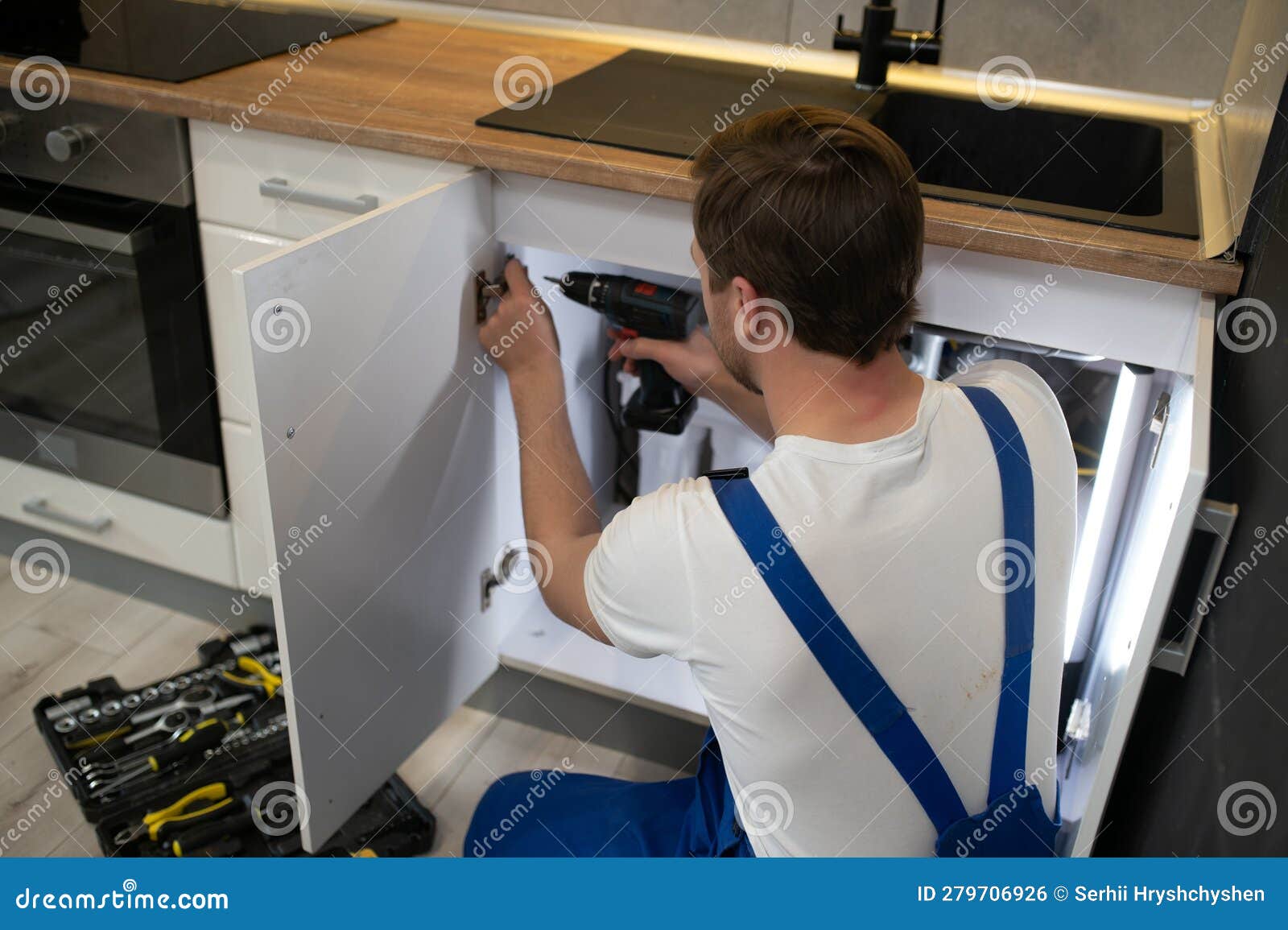 Kitchen Installation. Worker Assembling Furniture Stock Photo - Image ...