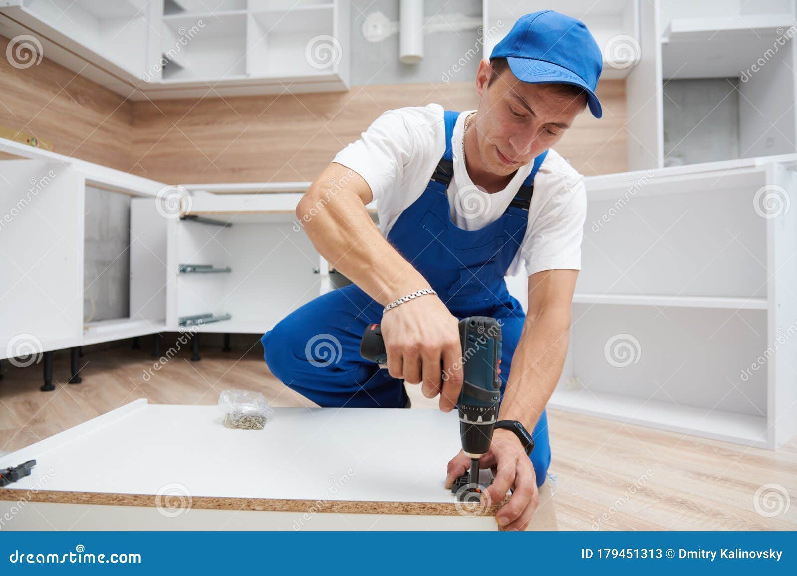 Kitchen Installation. Worker Assembling Furniture Stock Image - Image ...