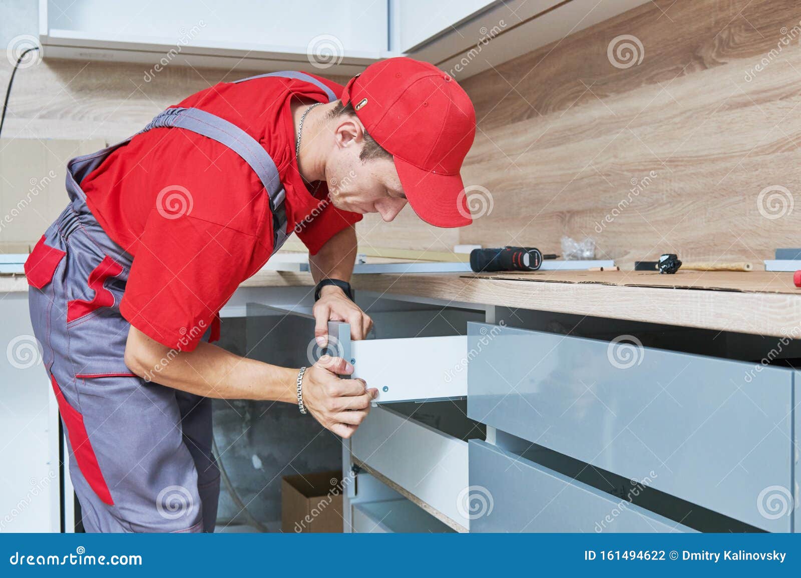 Kitchen Installation. Worker Assembling Furniture Stock Photo - Image ...