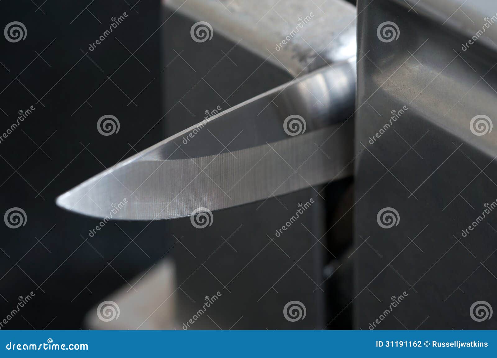 Kitchen Knife in a Sharpening Tool Stock Photo - Image of cooking ...