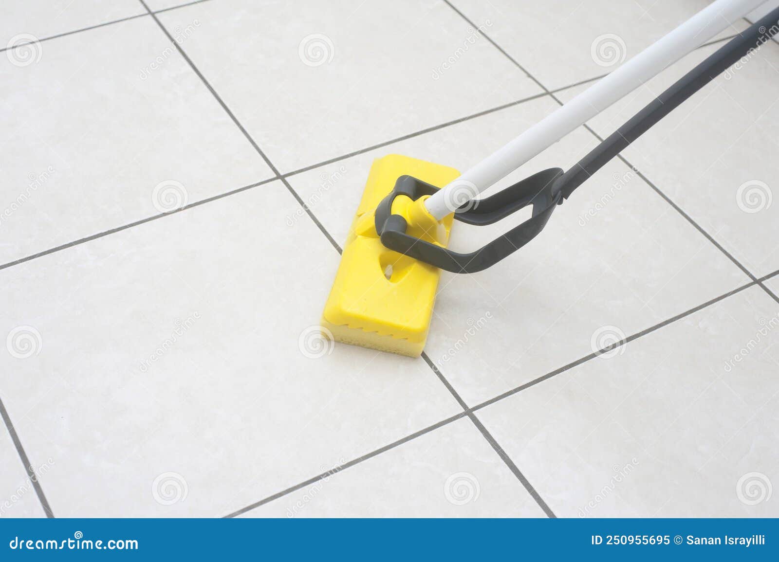 Kitchen Mop Being Used To Clean a Modern White Tiled Kitchen Floor ...