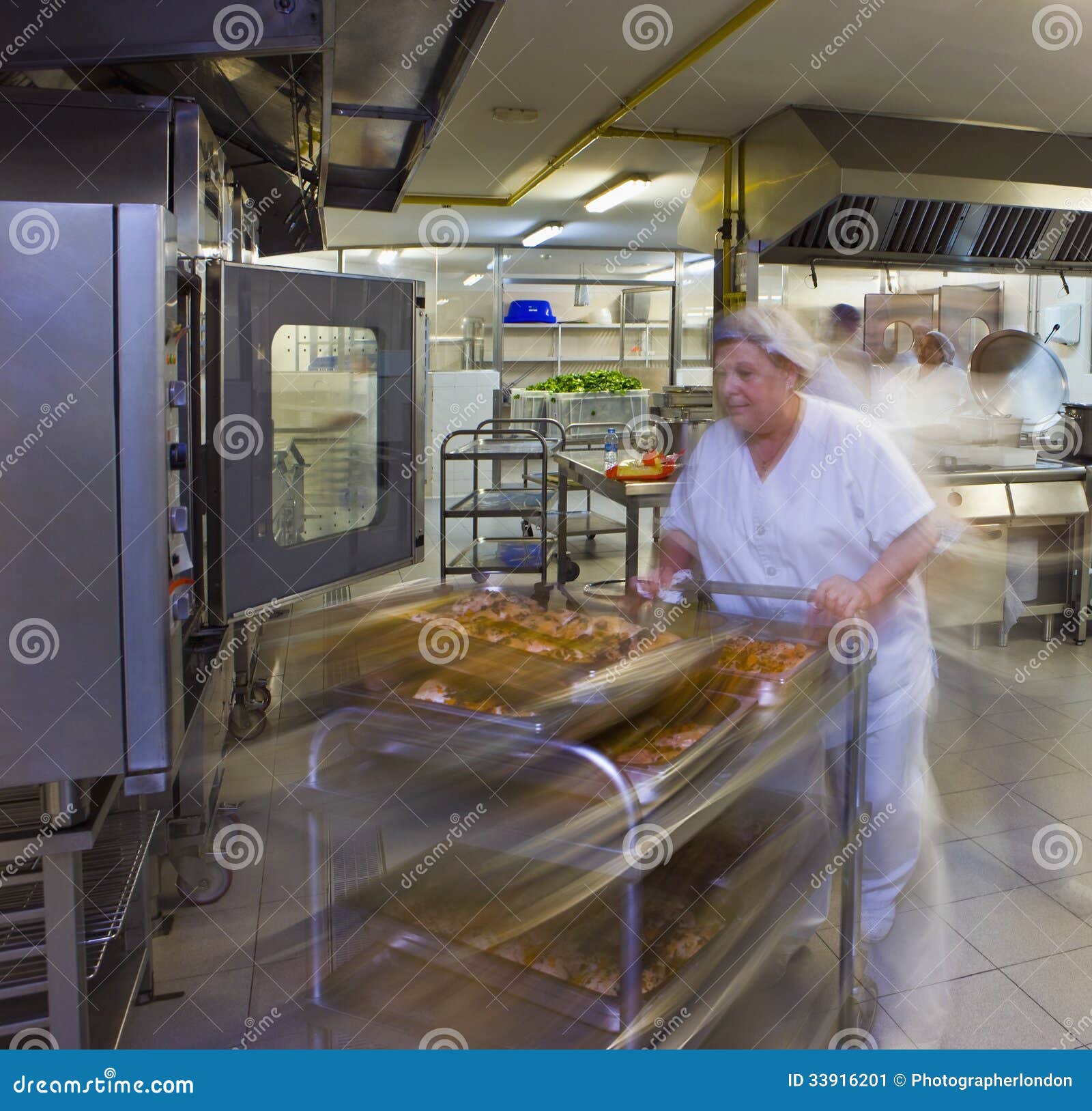 Kitchen Porter Pushes a Trolley of Pastries Stock Image - Image of ...