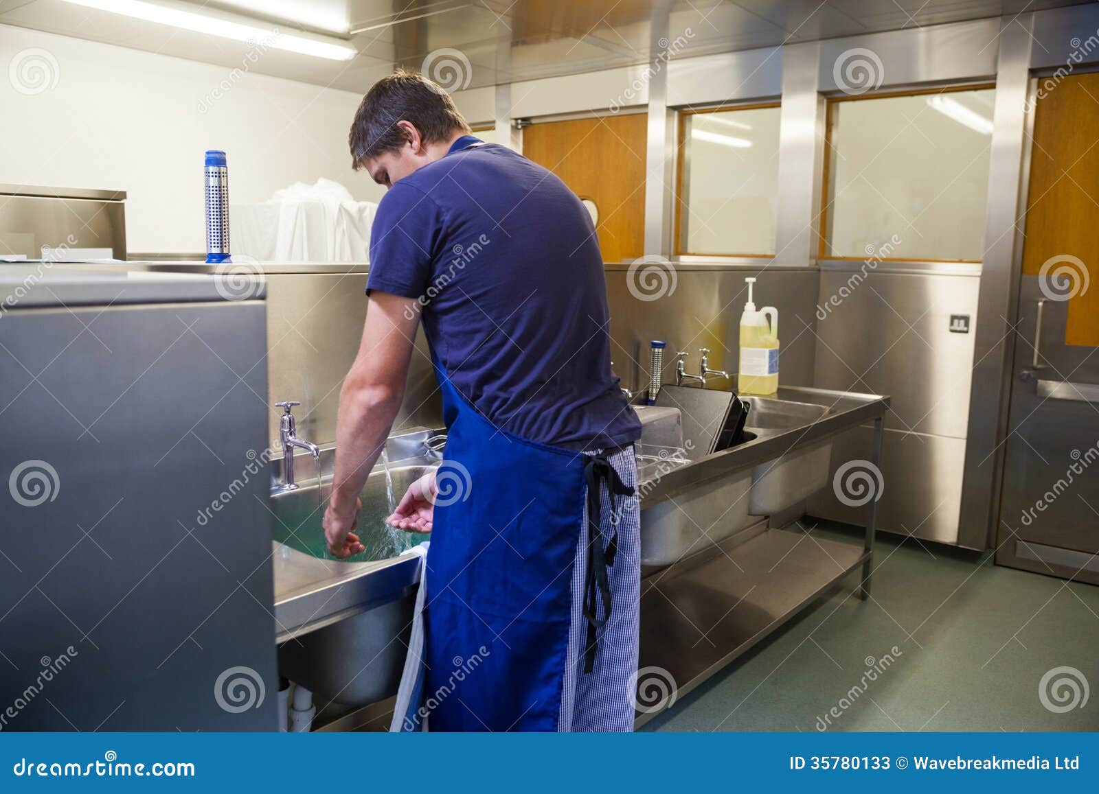 Kitchen Porter Washing Up at Sink Stock Image - Image of standing ...